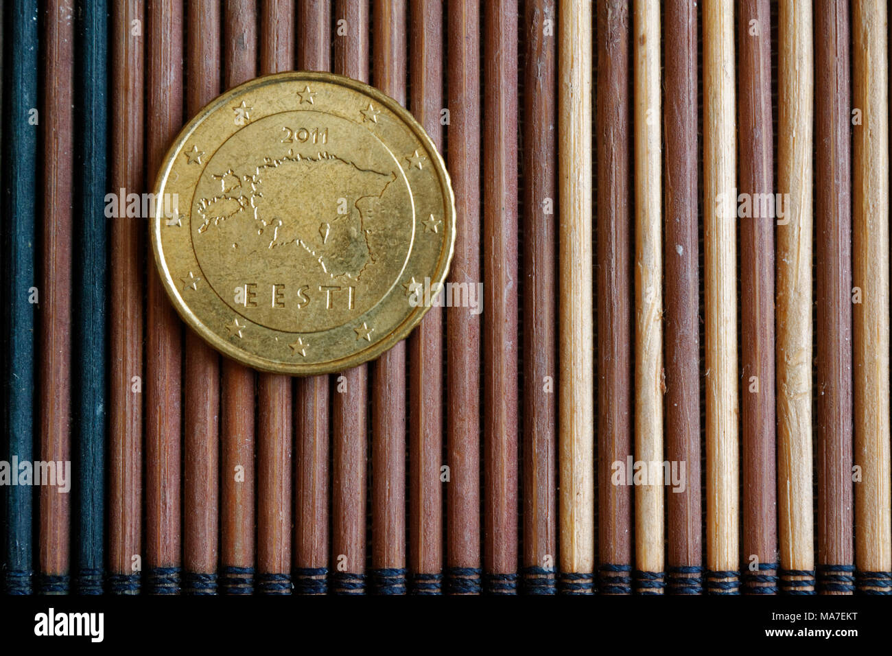 One euro coin lie on wooden bamboo table Denomination is fifteen euro ...