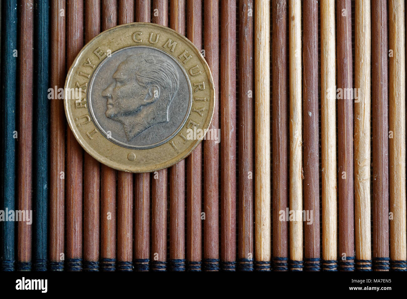 One Turkish coin denomination is 1 lira lie on wooden bamboo table ...