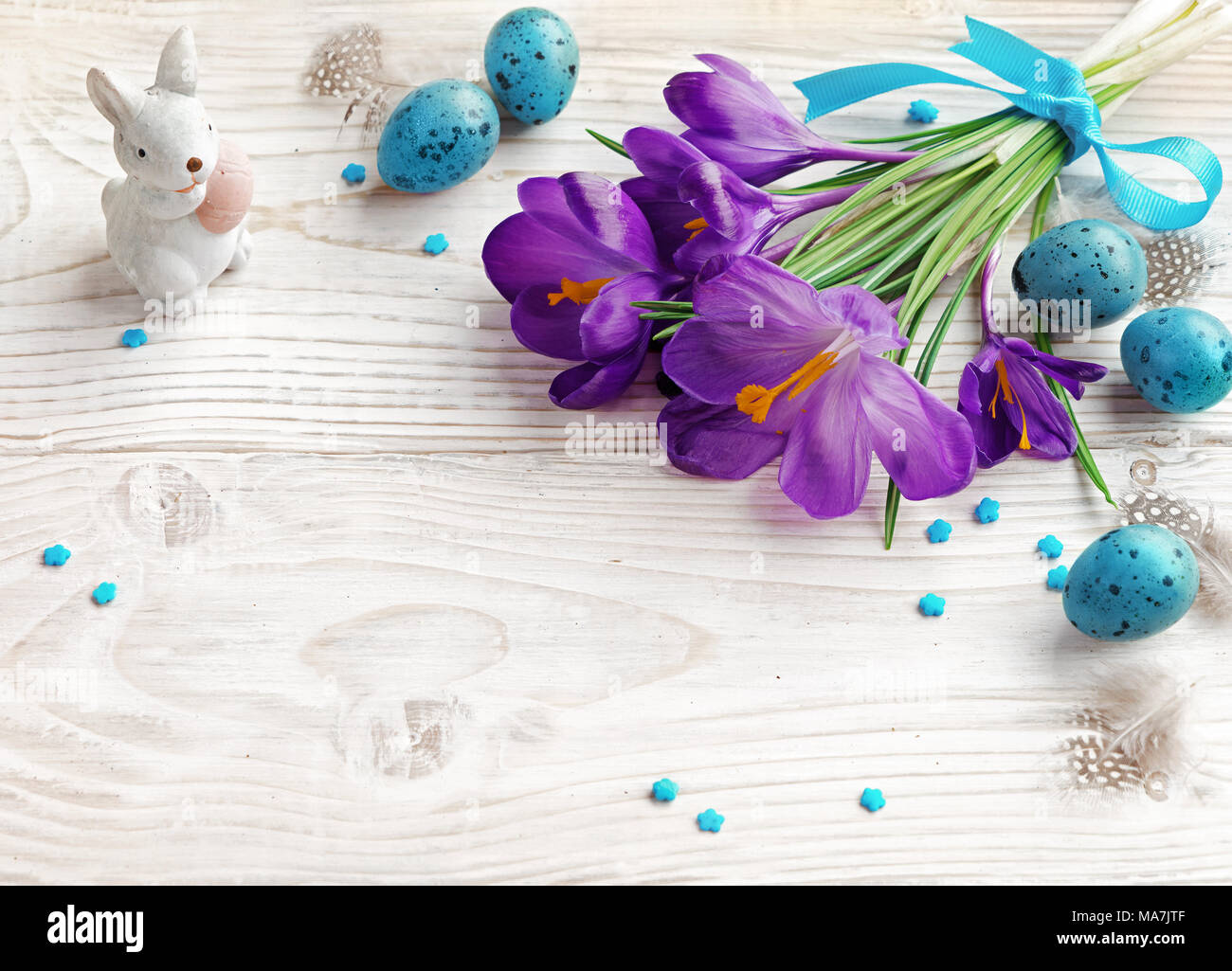 Easter background with Easter eggs and spring flowers. Top view with ...