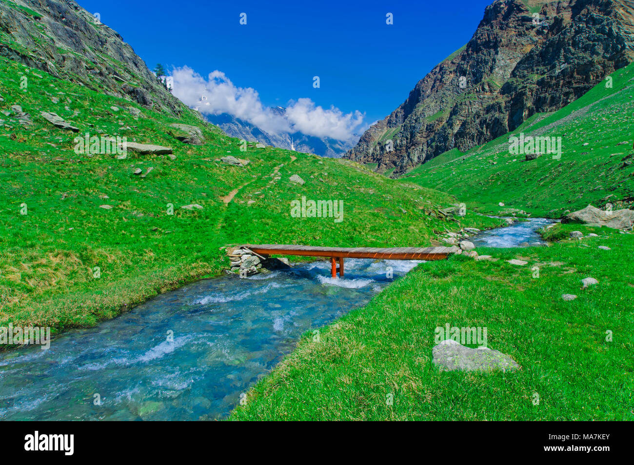 water stream and bridge in mountain landscape, Gran Paradiso. Italy ...