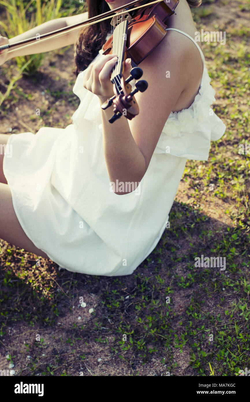Beautiful women enjoy playing violin Stock Photo - Alamy
