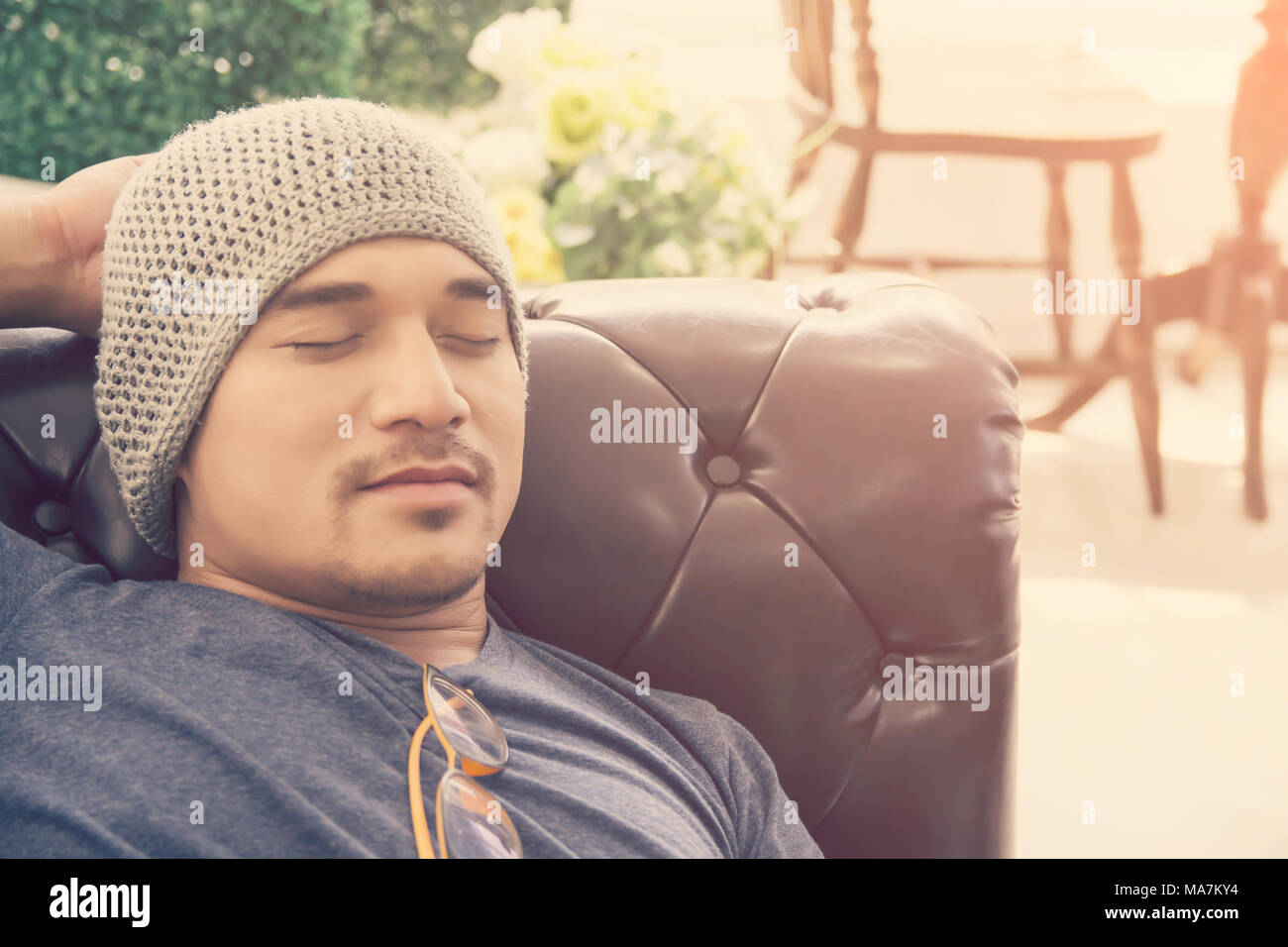 Young man laying on couch hi-res stock photography and images - Alamy