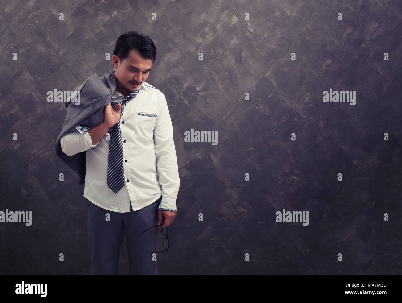 A grumpy looking businessman that looks like he has been up all night ...