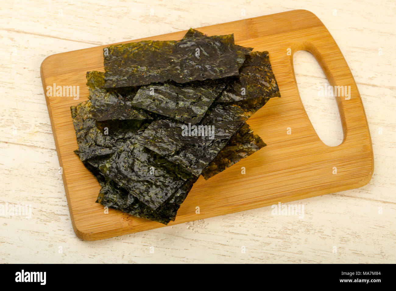 Crispy Nori sheets chips over wooden background Stock Photo - Alamy