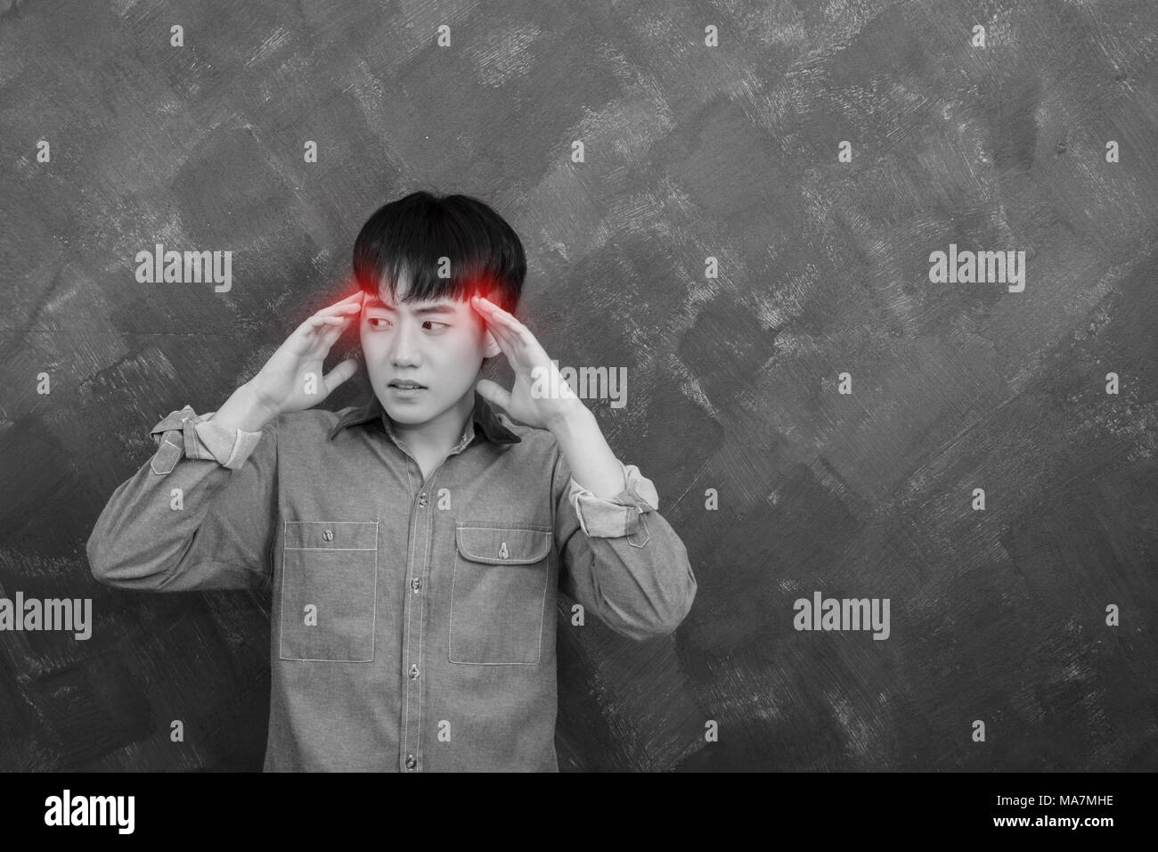 Headache handsome young man posing against a grunge background Stock ...