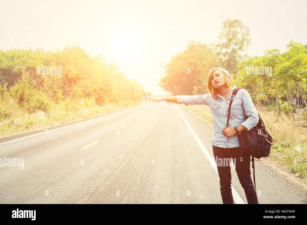 Young female hitchhiker standing roadside hi-res stock photography and ...