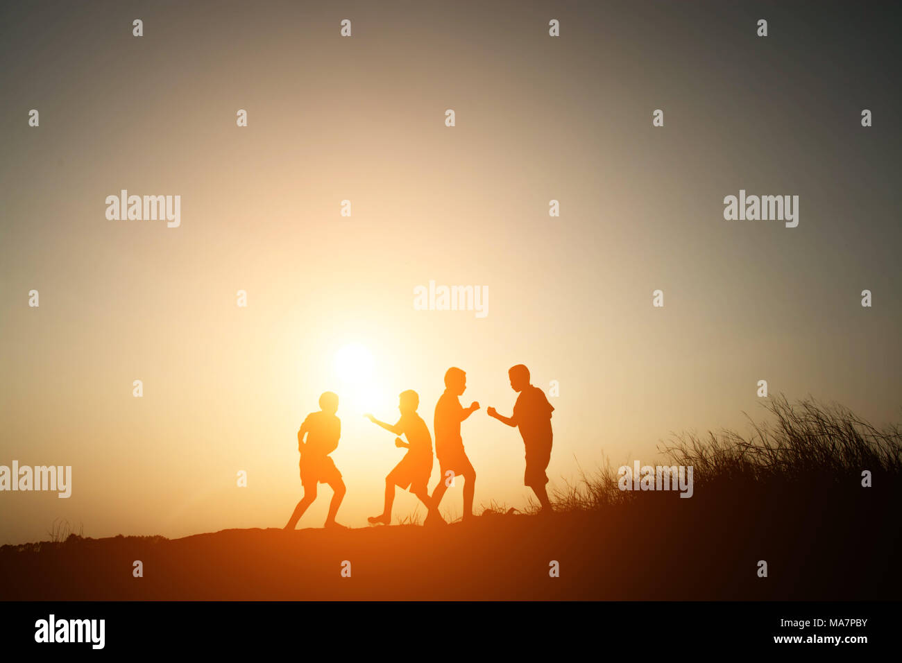 Children playing on summer sunset happy time Stock Photo - Alamy