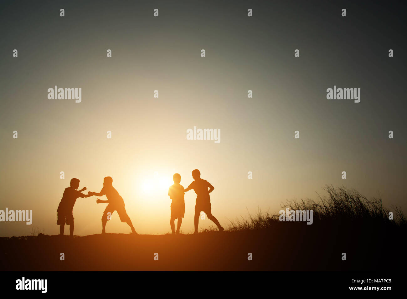 Children playing on summer sunset happy time Stock Photo - Alamy
