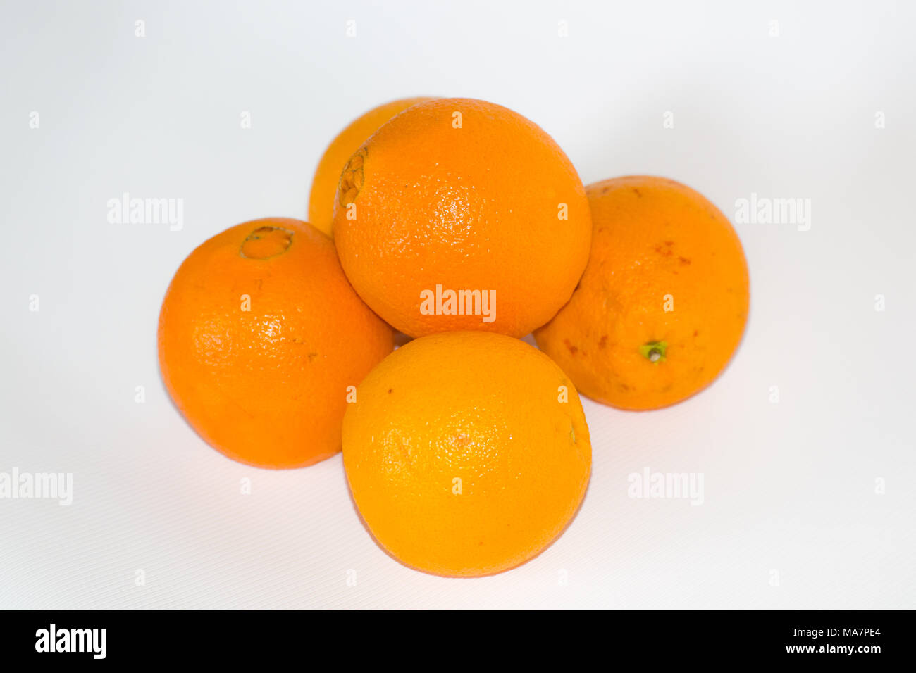 five oranges on white background Stock Photo - Alamy
