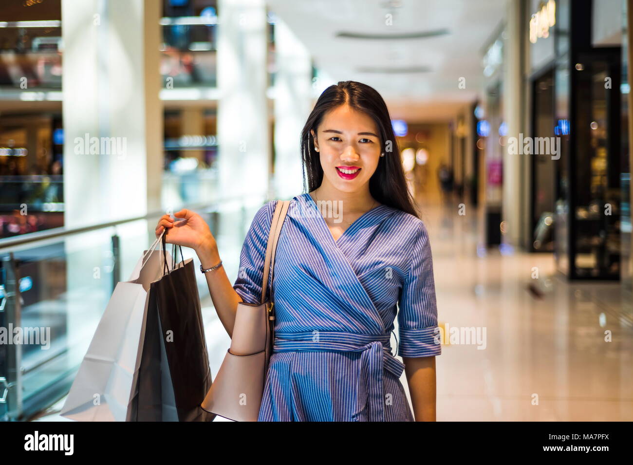 Happy Asian girl doing shopping in the mall Stock Photo - Alamy