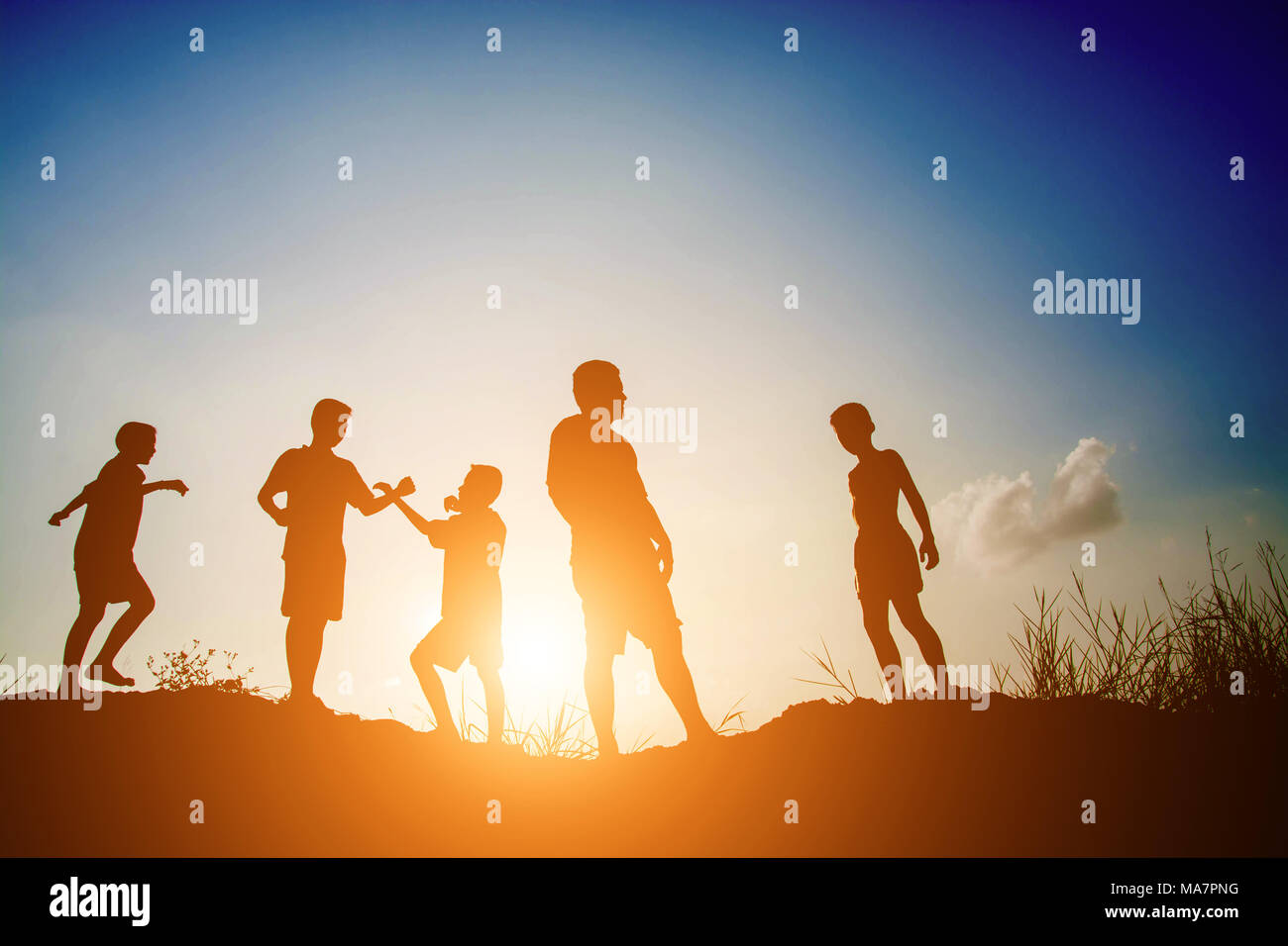 Children playing on summer sunset happy time Stock Photo - Alamy