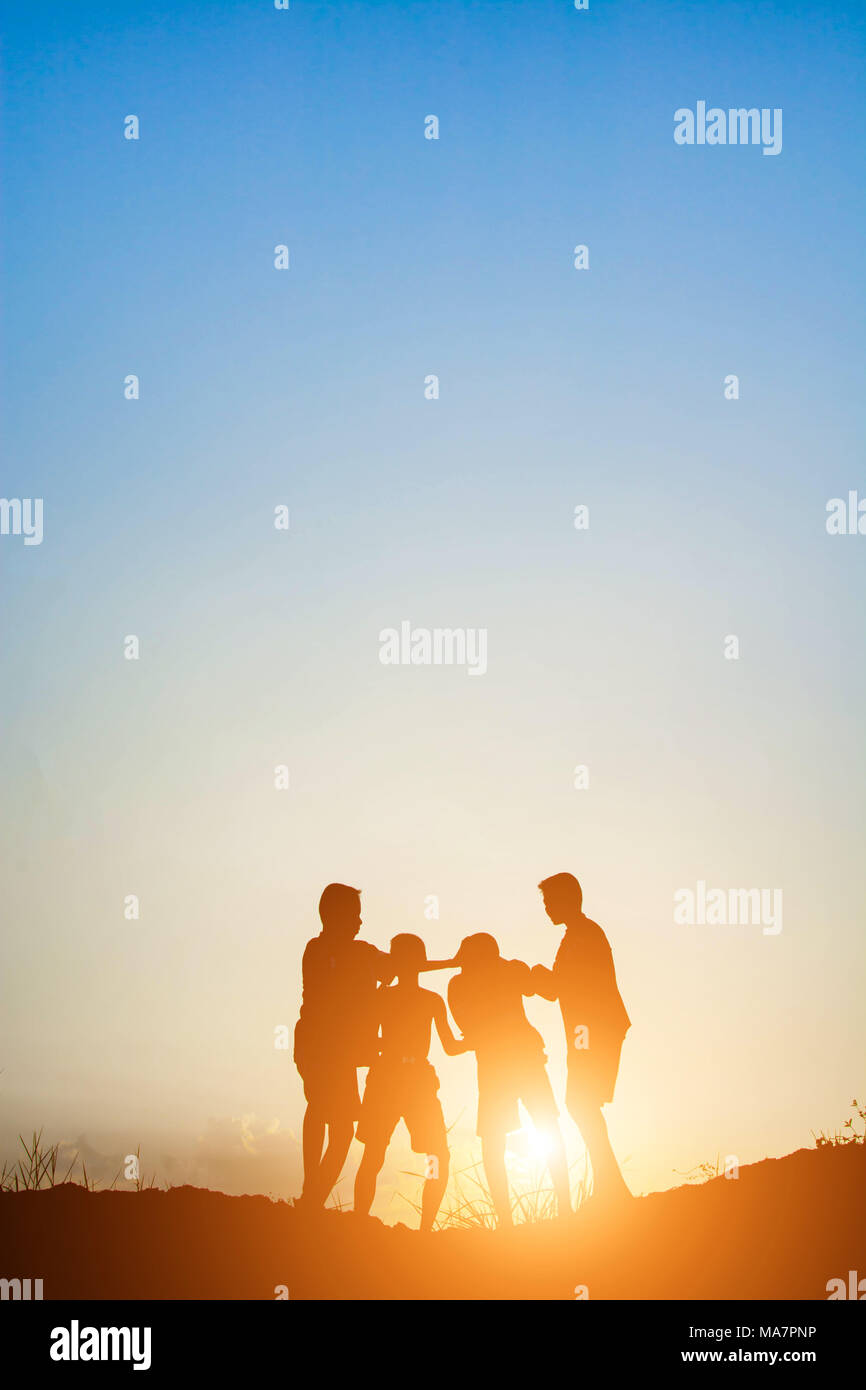 Children playing on summer sunset happy time Stock Photo - Alamy