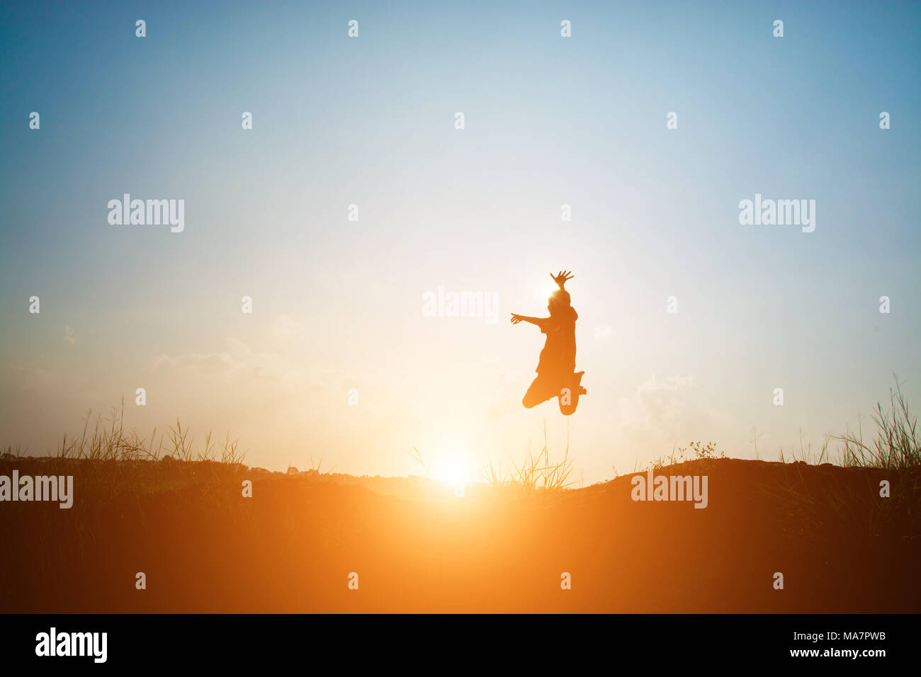 Happy young kids jumping against beautiful sunset Stock Photo - Alamy