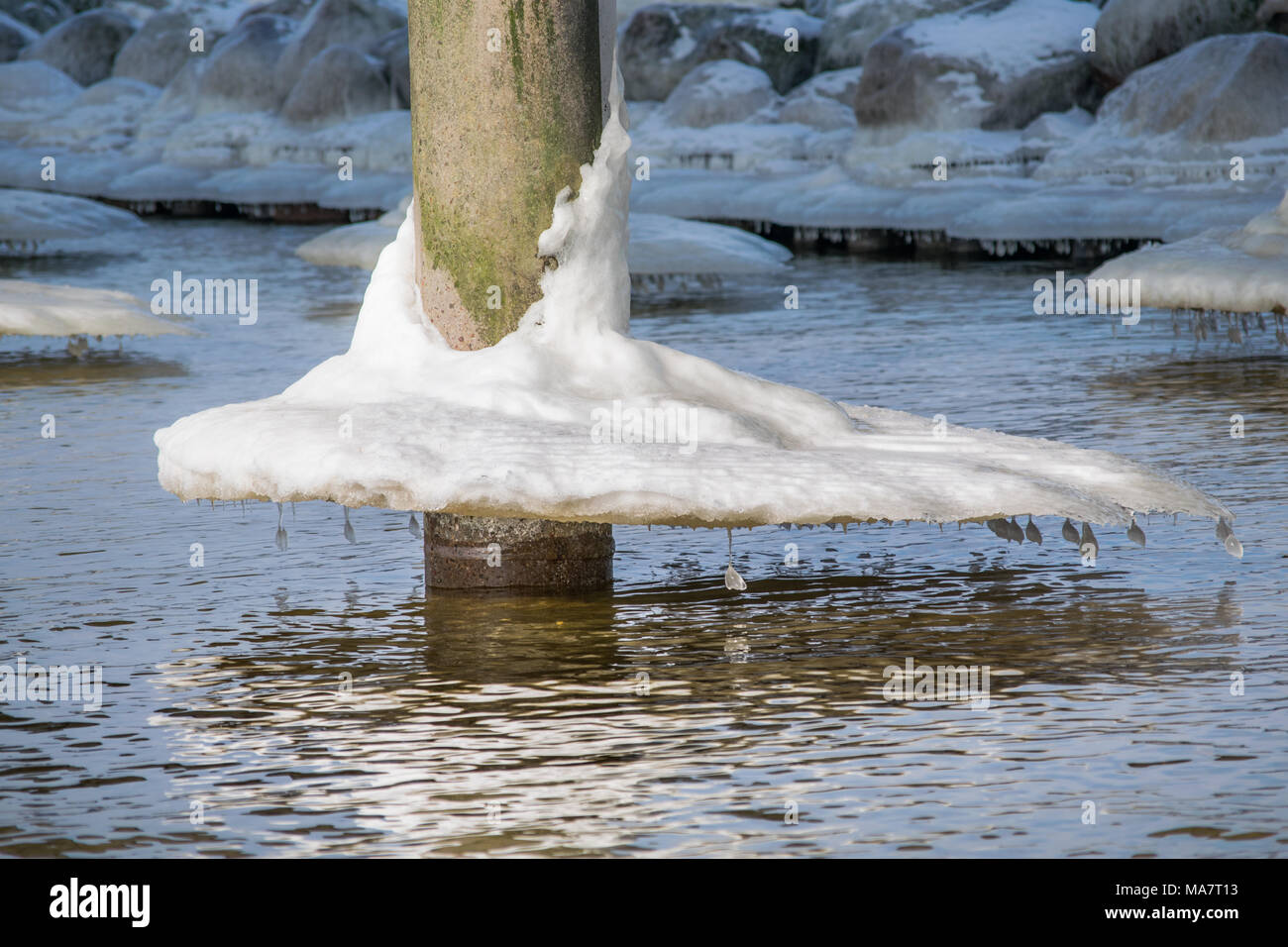 snow and ice on bridge pole Stock Photo - Alamy