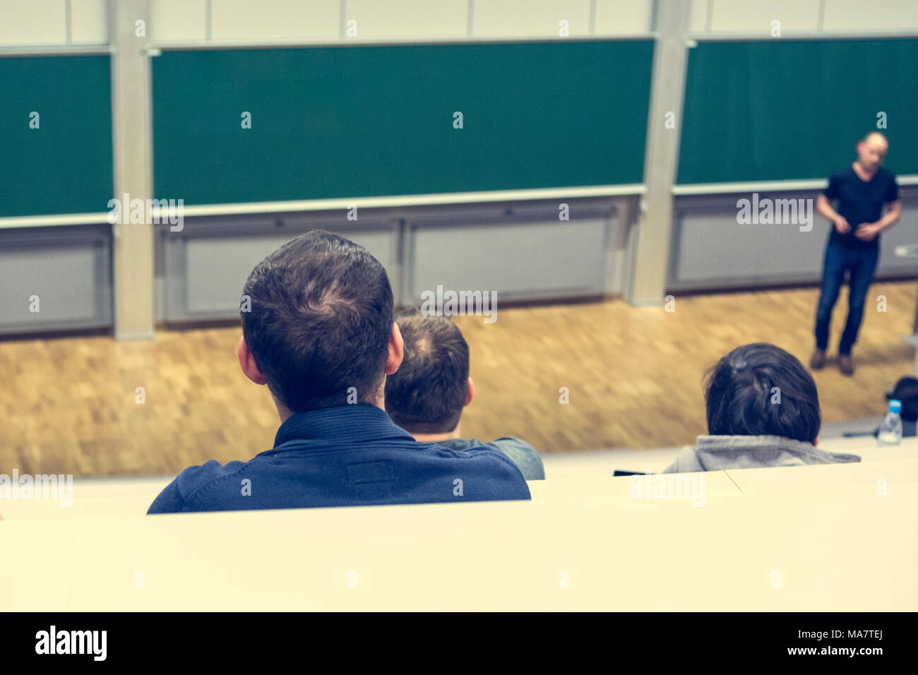 Audience at a lecture. People taking notes during presentation Stock ...