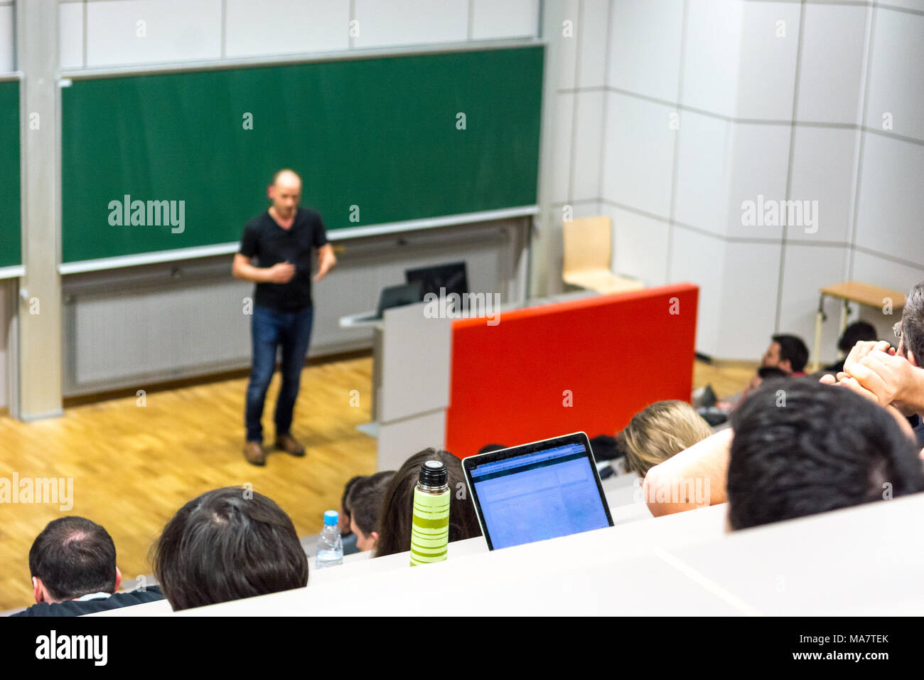 Audience at a lecture. People taking notes during presentation Stock ...