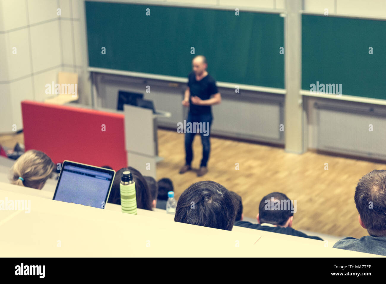 Audience at a lecture. People taking notes during presentation Stock ...
