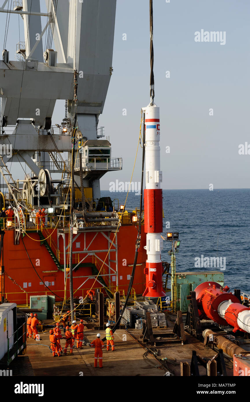 A Menck subsea pile hammer is lifted from its cradle on the deck of the ...