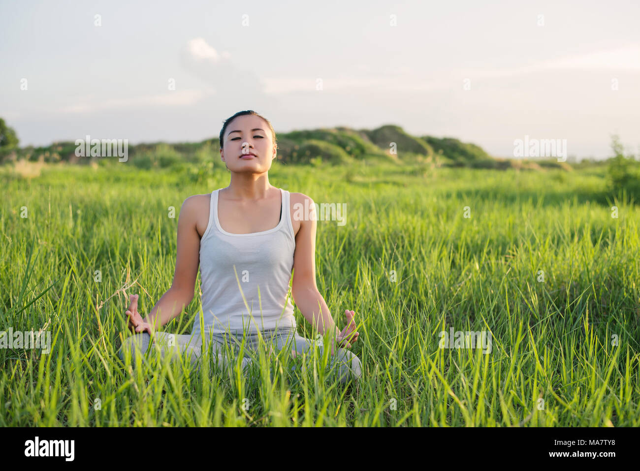 Yoga woman In the lotus posture Stock Photo - Alamy