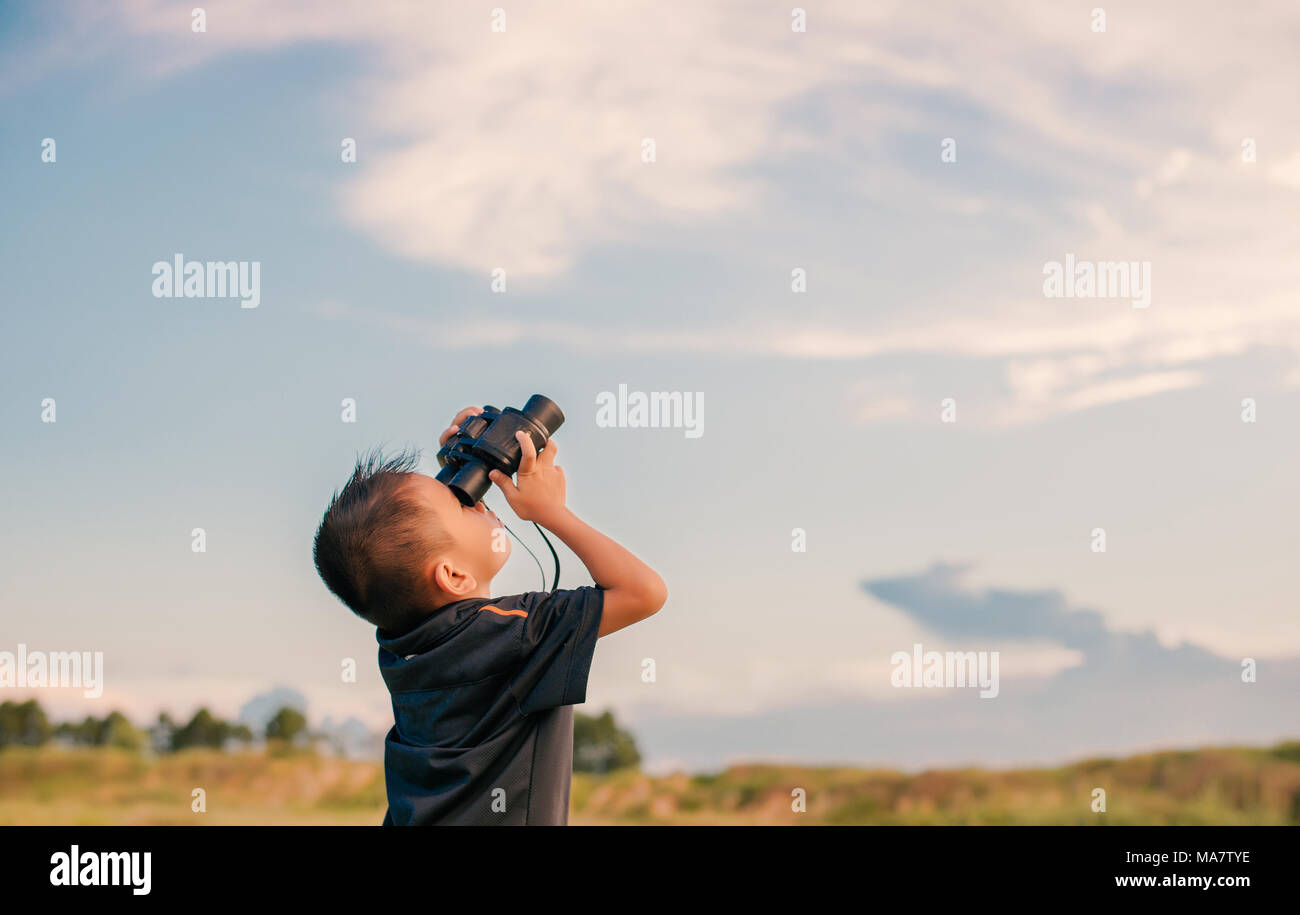 Happy kid playing binoculars in the meadows Stock Photo - Alamy