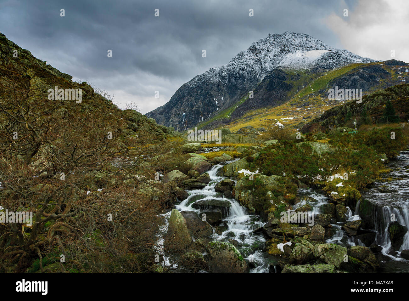 Snow capped Tryfan Mountain, Afon ogwen cascading its way down the ...