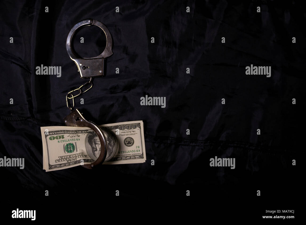 women's hands in handcuffs with dollars in her hands Stock Photo - Alamy