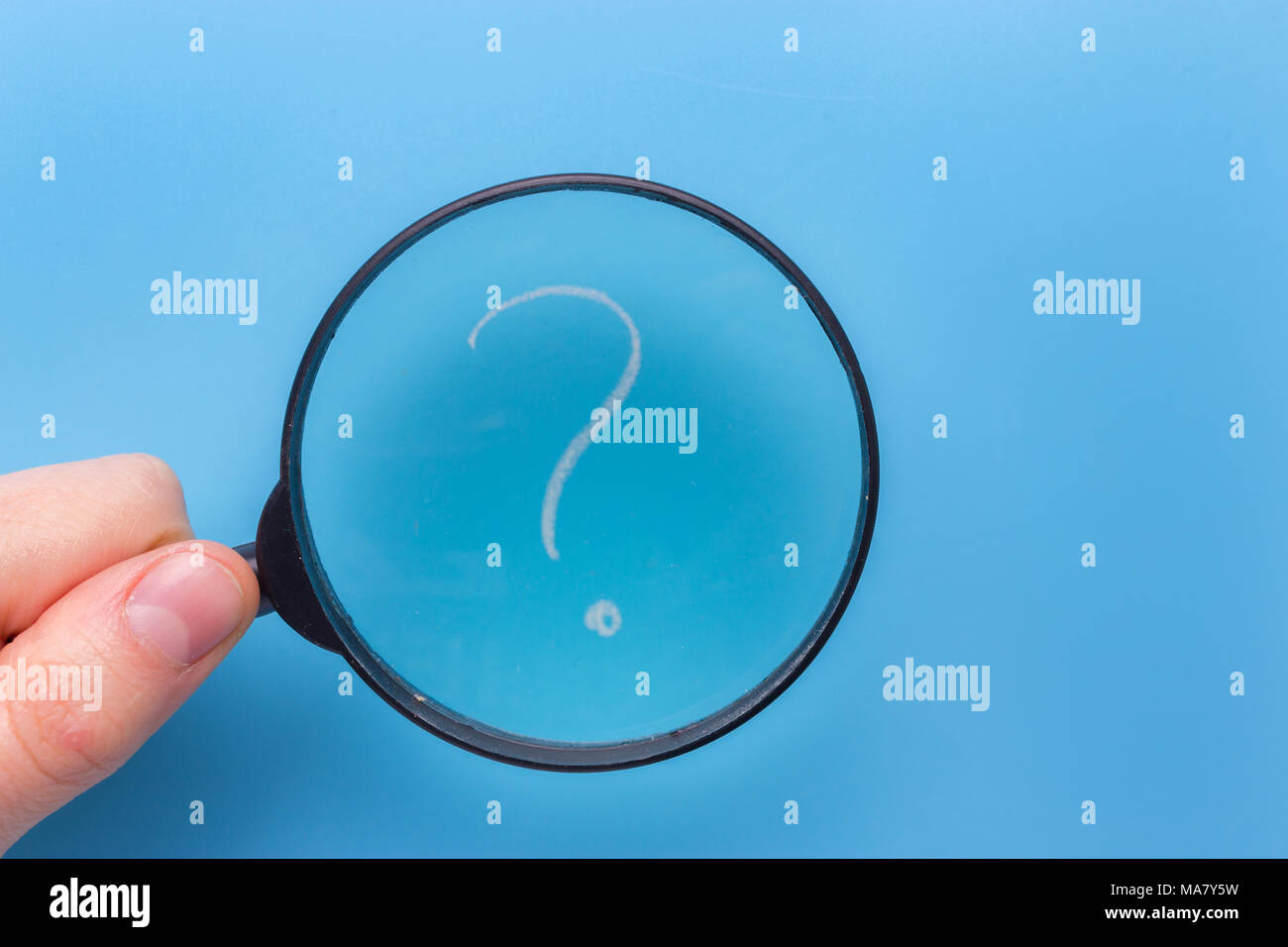 question mark under a magnifying glass with blue background Stock Photo ...