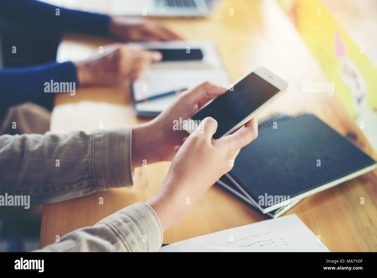 business woman hand working on smart phone with business graph ...