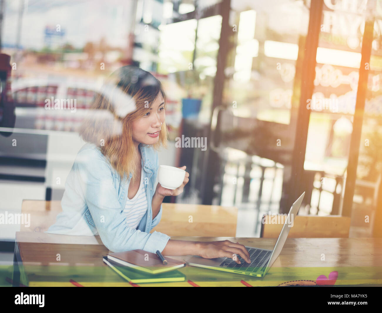 Young beautiful hipster woman work at cafe with window reflection Stock ...