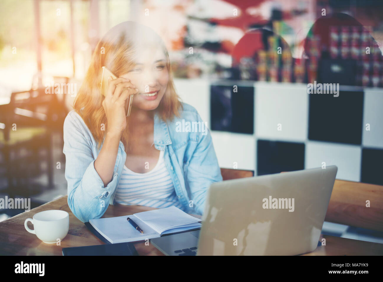 Young hipster woman talking phone and working at coffee shop Stock ...