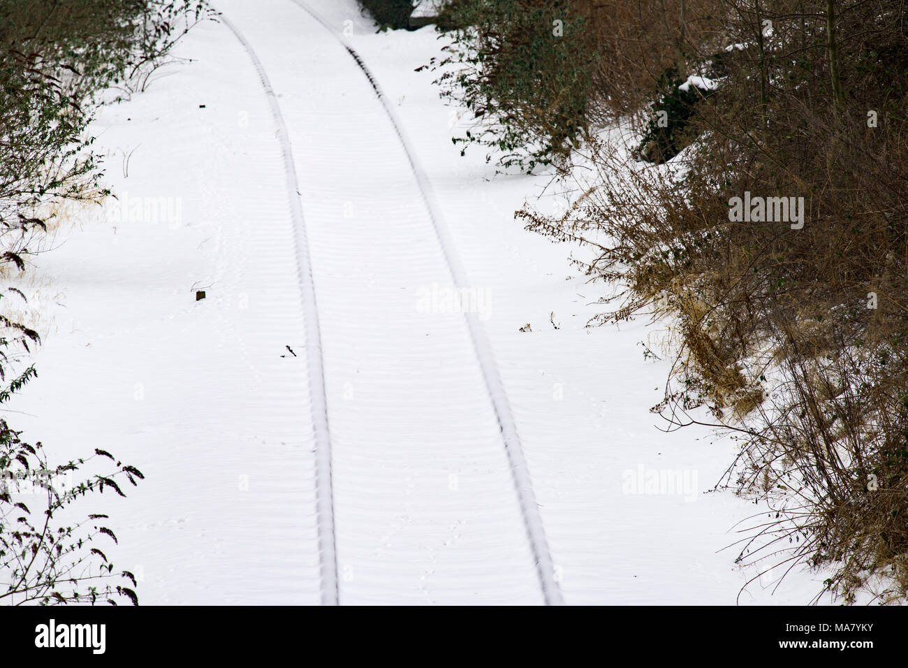 Train tracks covered in clean white snow following the Beast from the ...