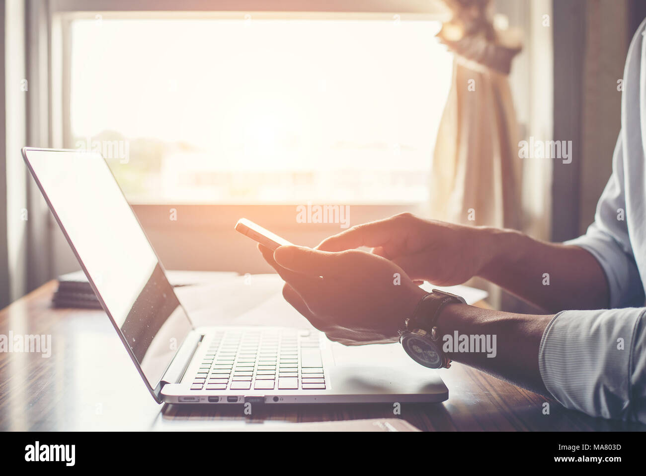 Businessman hands using cell phone with laptop at office desk Stock ...