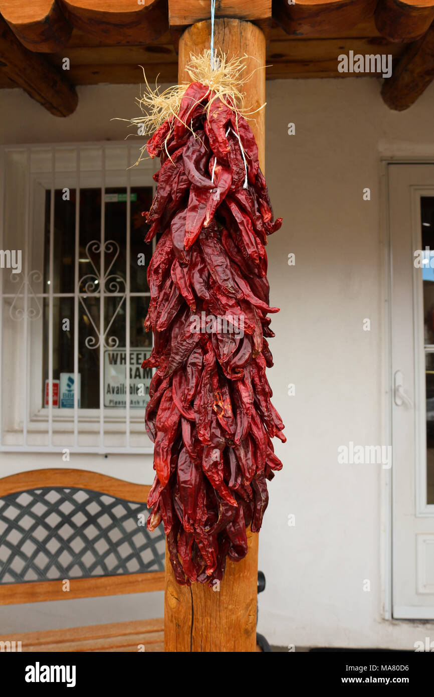 dried chilli hanging by building Stock Photo - Alamy