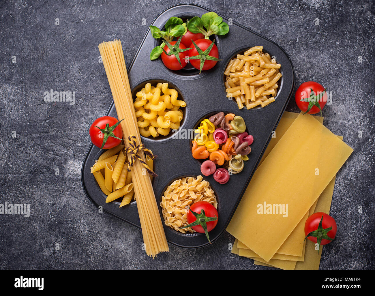 Various type of pasta and cherry tomato. Top view Stock Photo - Alamy