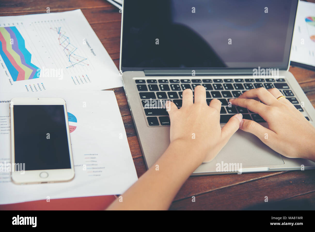 Young business woman hands analysis with business chart and typing ...
