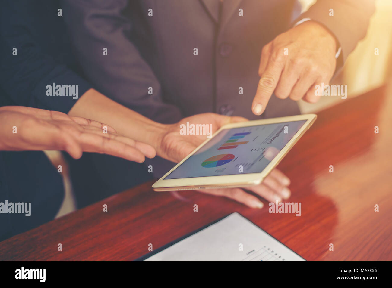 Graphs and charts being demonstrated on the screen of a touch-pad,time ...