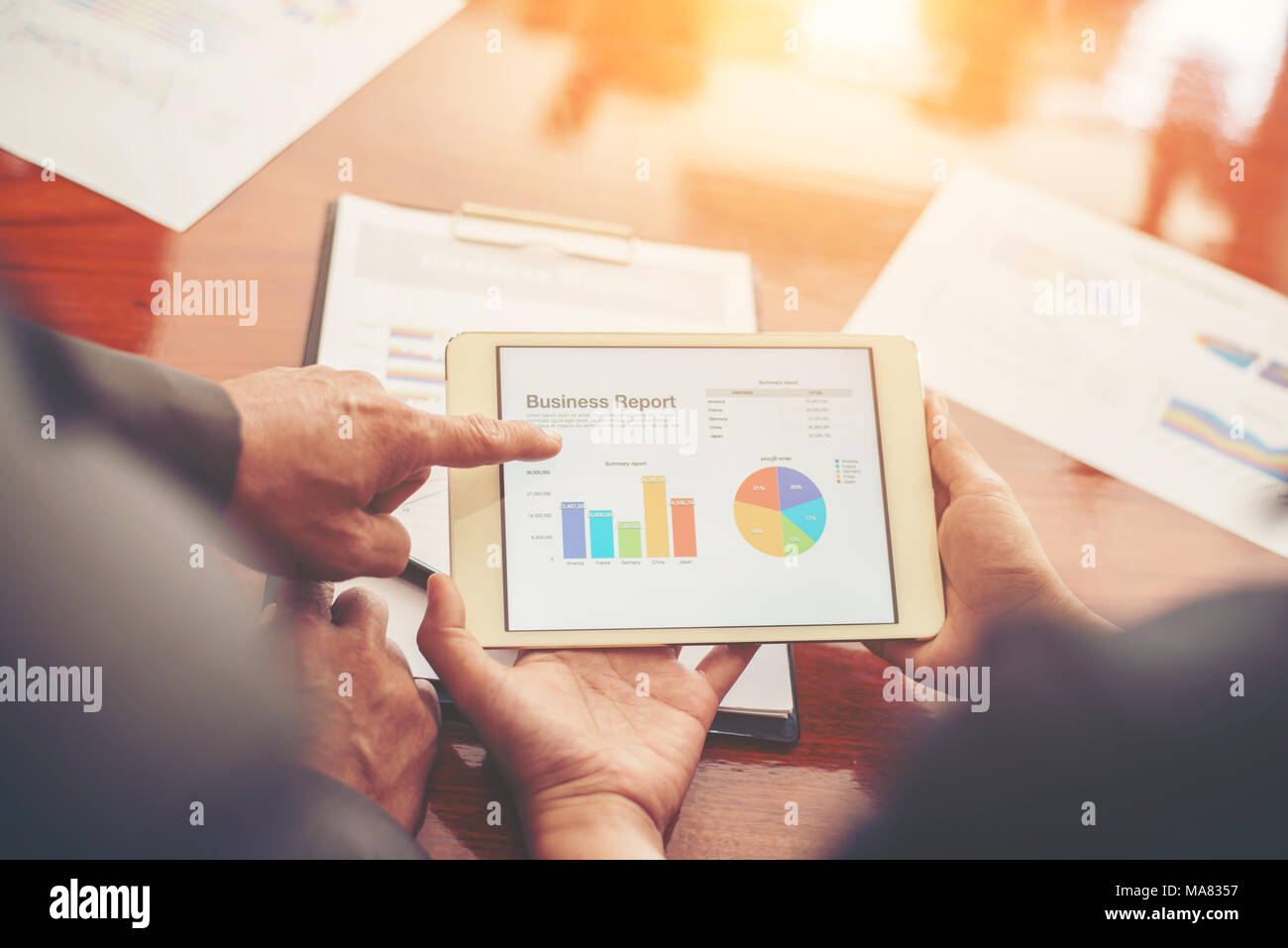 Graphs and charts being demonstrated on the screen of a touch-pad,time ...