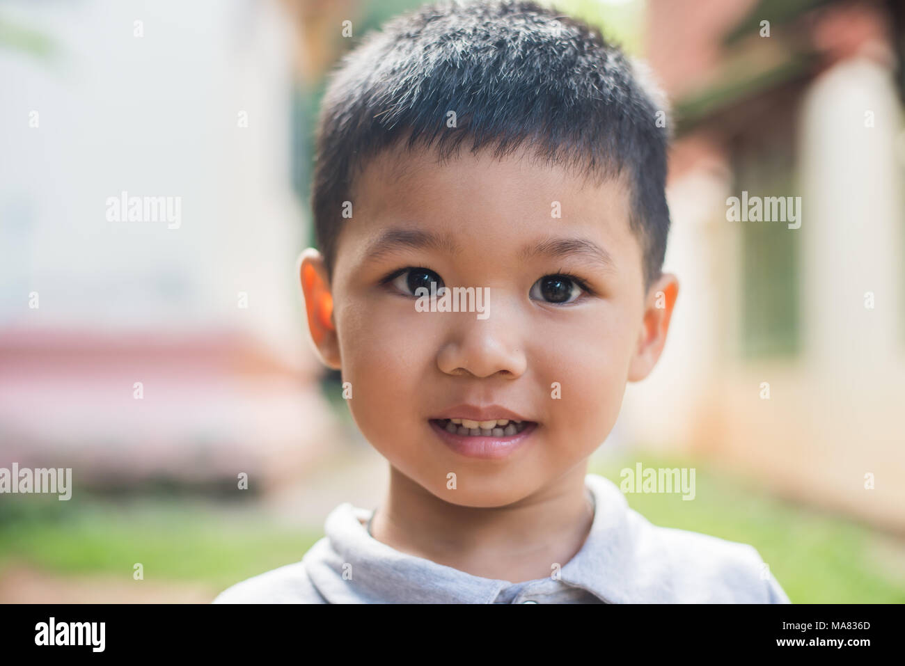 Innocent asian boy smiling in hi-res stock photography and images - Alamy