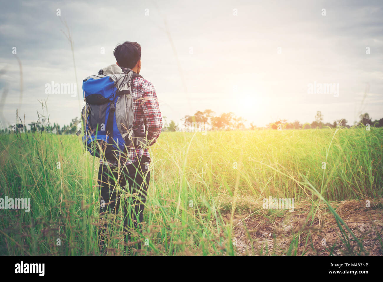 Hipster man with a backpack on his shoulders,time to go traveling ...