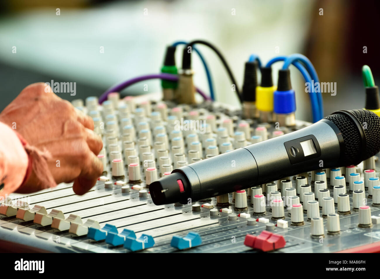 Sound engineer adjusting audio mixing console Stock Photo - Alamy