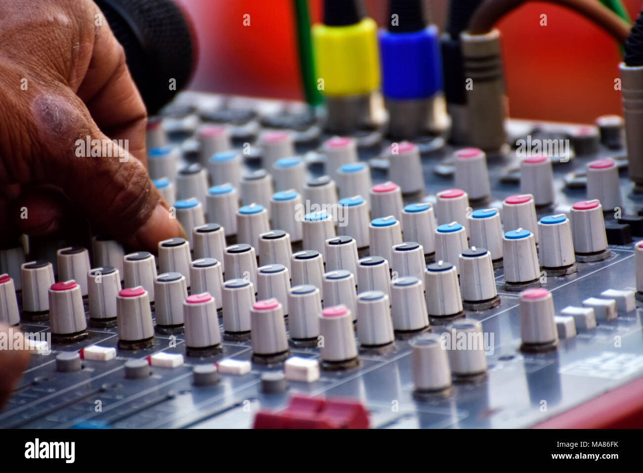 Sound engineer adjusting audio mixing console Stock Photo - Alamy