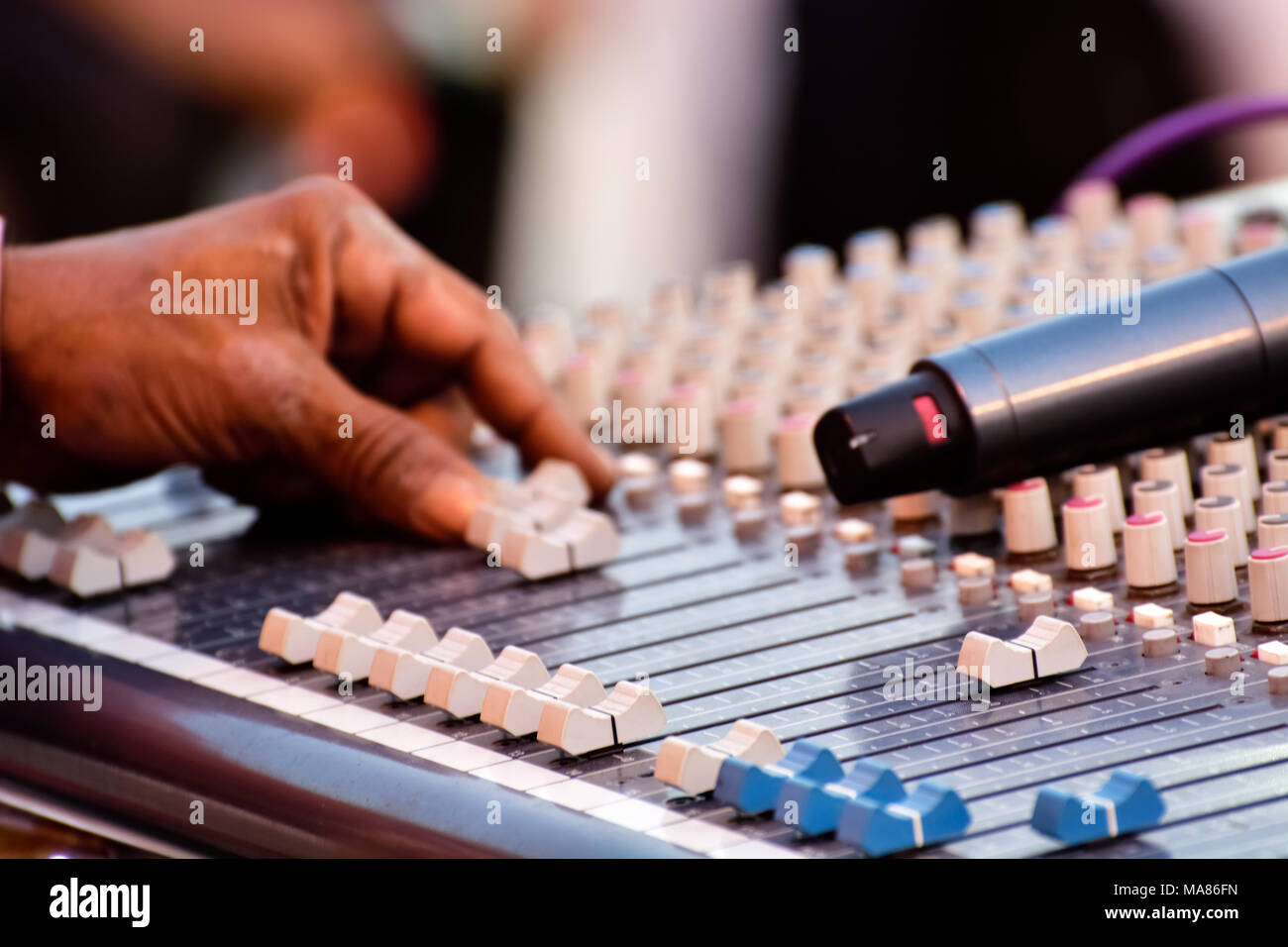 Sound engineer adjusting audio mixing console Stock Photo - Alamy