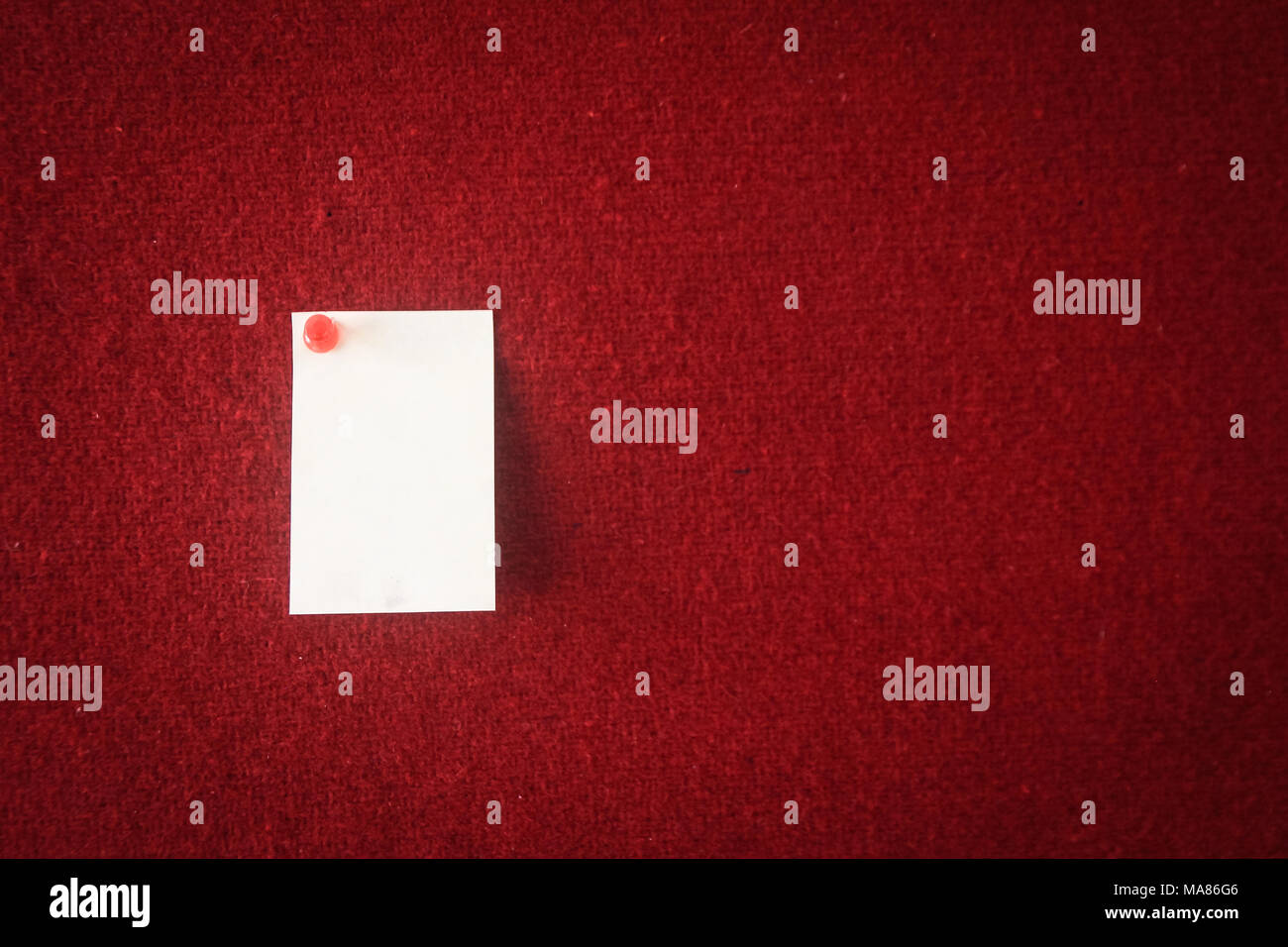 note paper pinned on a red board ready for filling in quotes Stock ...