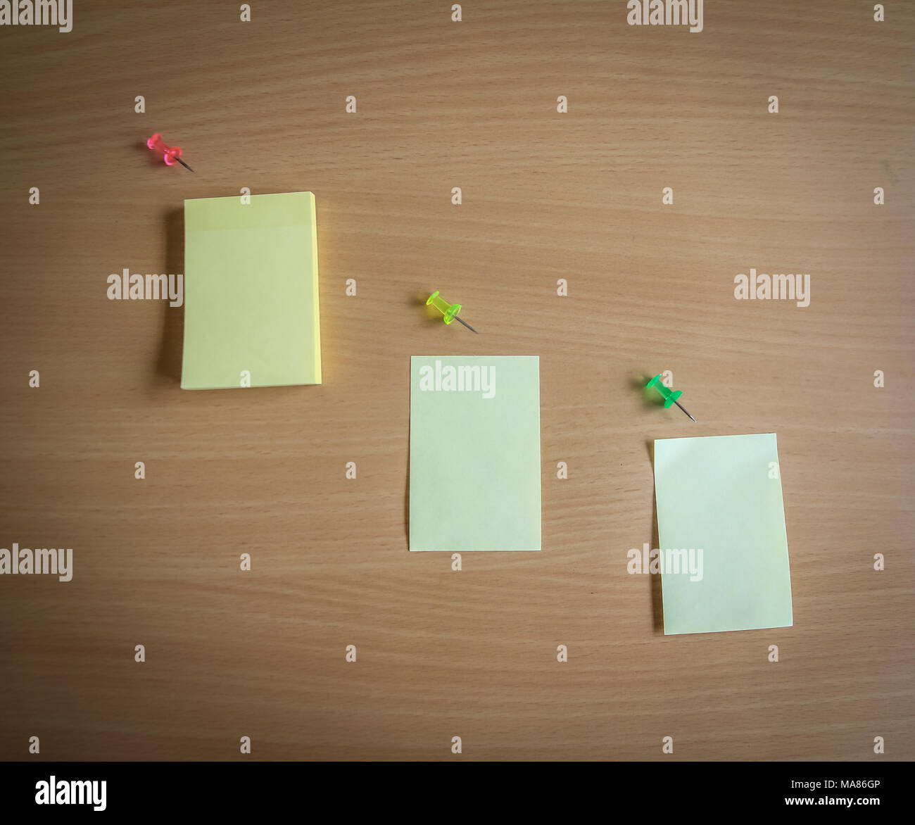 collection of pins and note paper bunch and loose papers on wooden ...