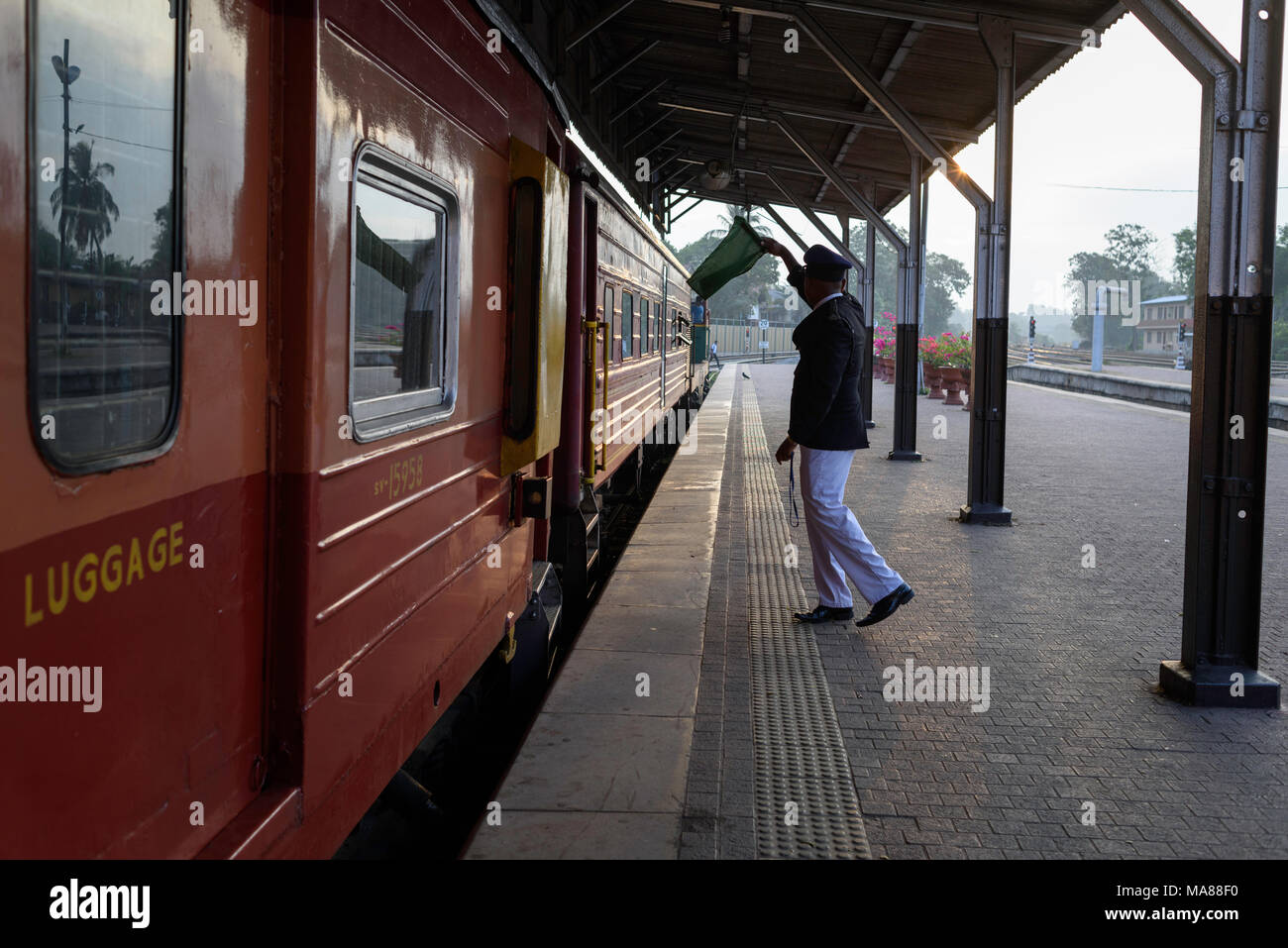 Train conductor giving way with a green flag at Colombo fort train ...
