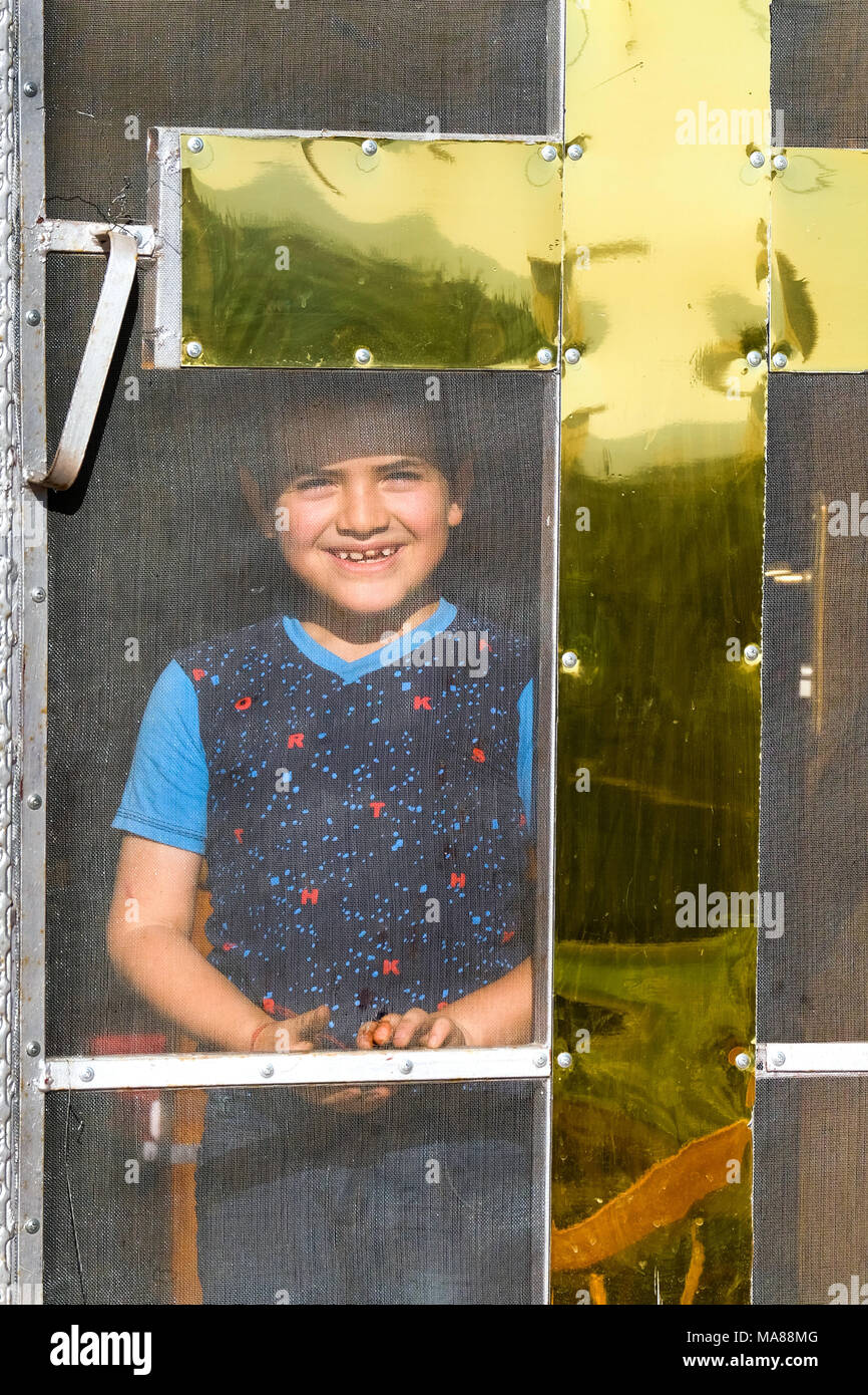 Boy behind a mosquito door Door to the Caldean church Mor Oraha in Levo ...