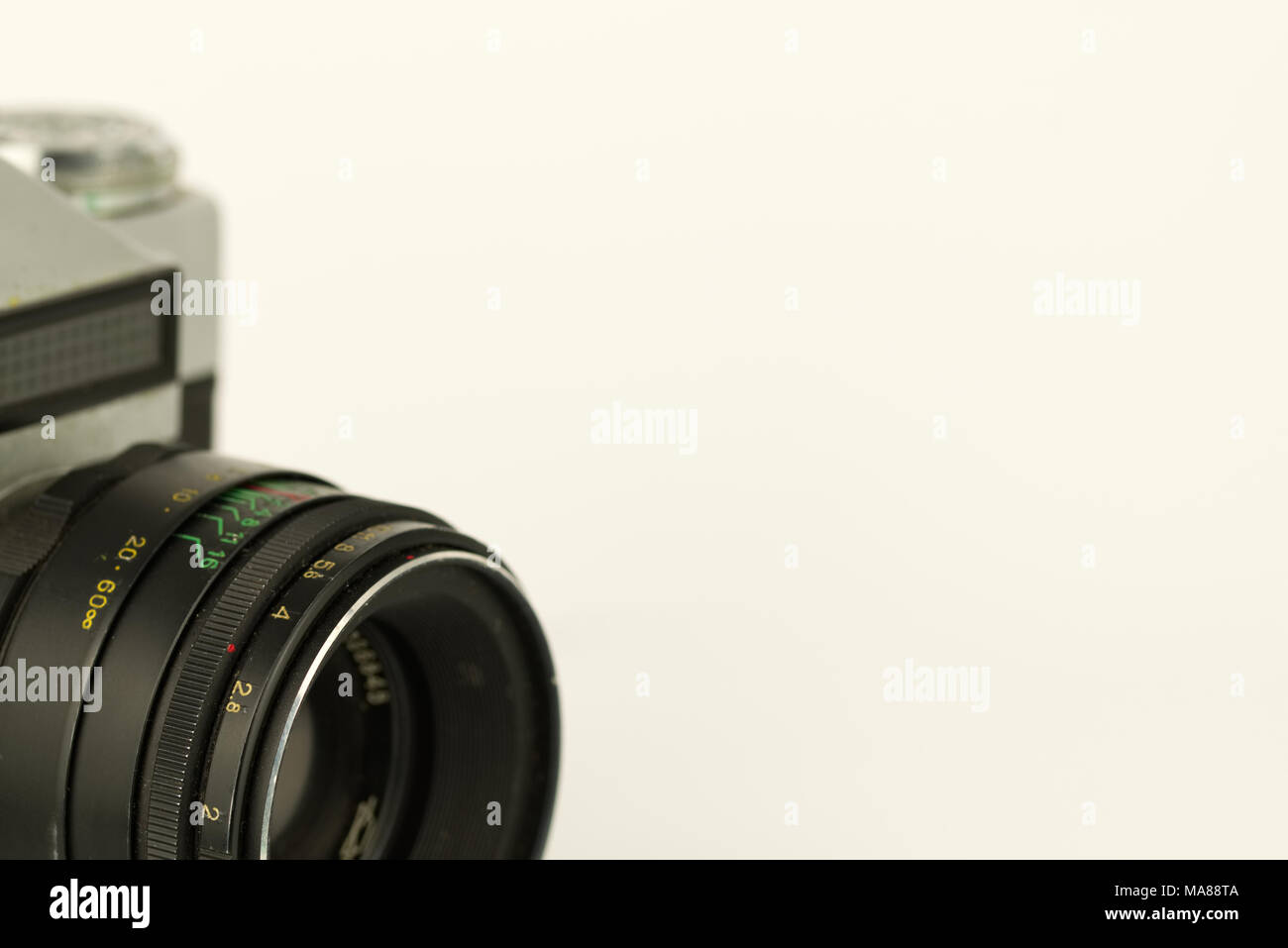 Old vintage camera showing the detail of the lens isolated on a white ...