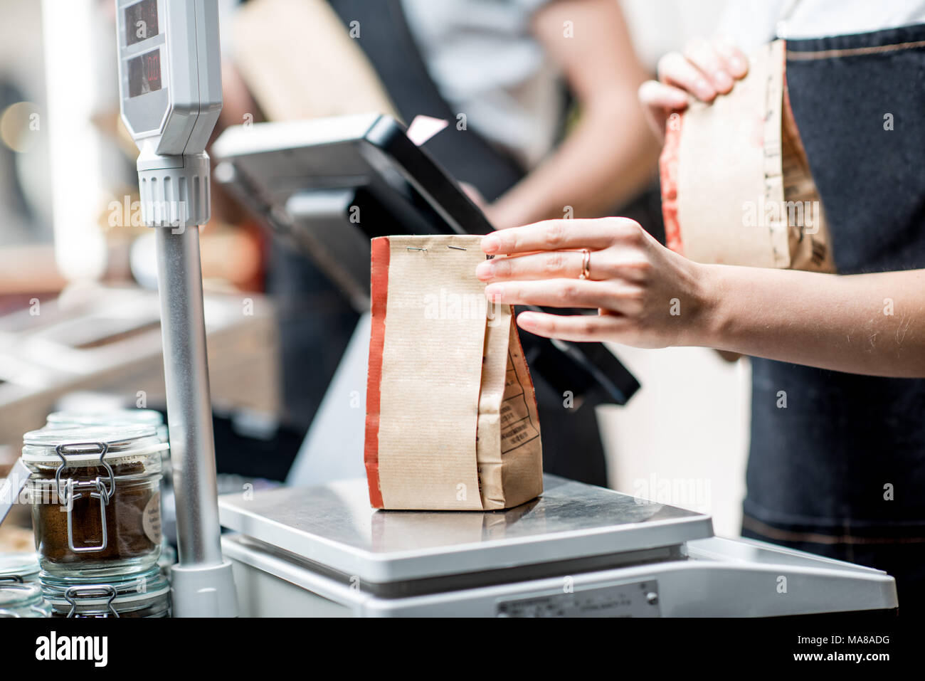Weighing paper bag with coffee beans in the coffee store Stock Photo ...