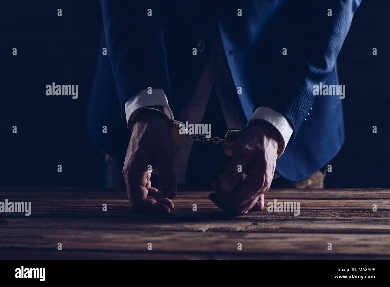 Arrested male businessman with handcuffs. Law and corruption concept ...