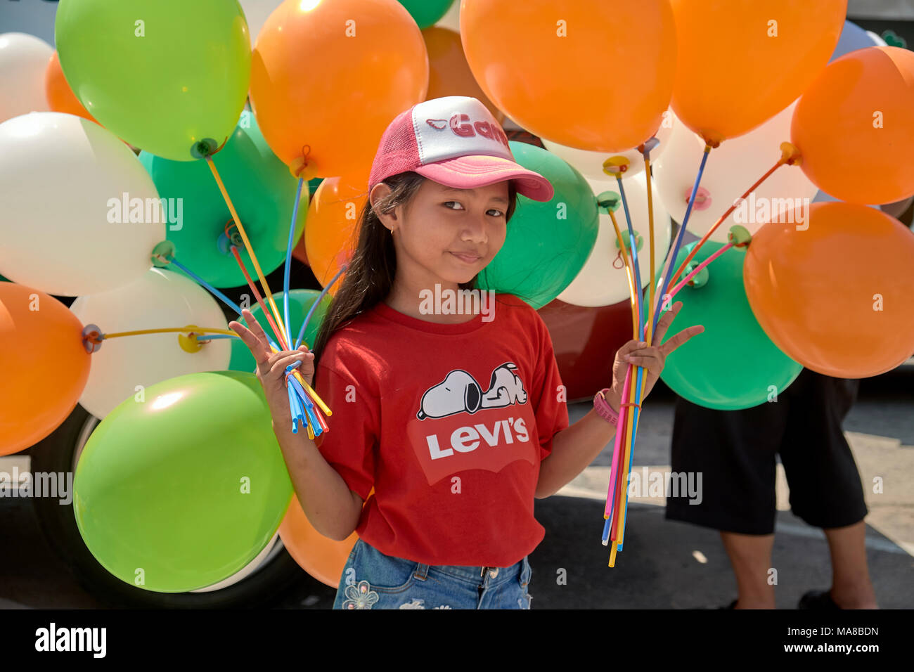 Child with balloons. Happy and cute child with a clutch of balloons ...